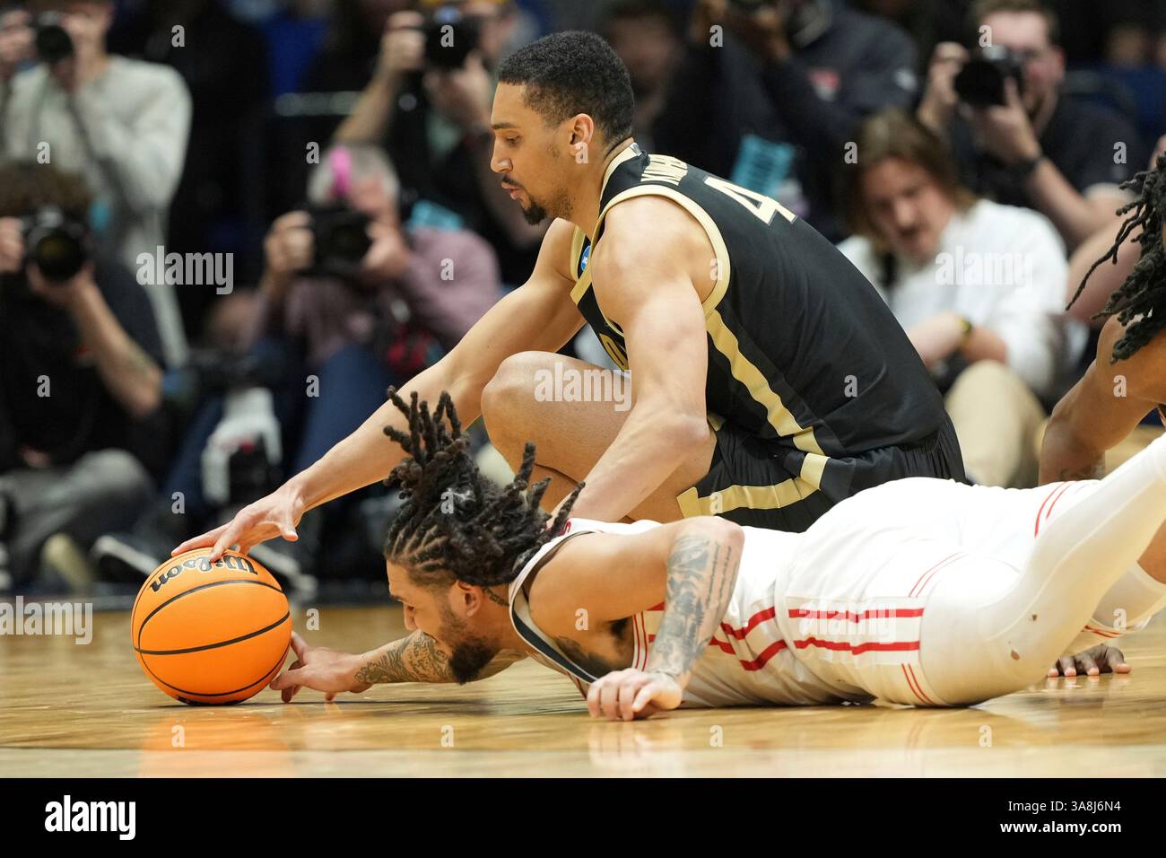 Houston's Emanuel Sharp, bottom, and Purdue's Trey Kaufman-Renn dive ...