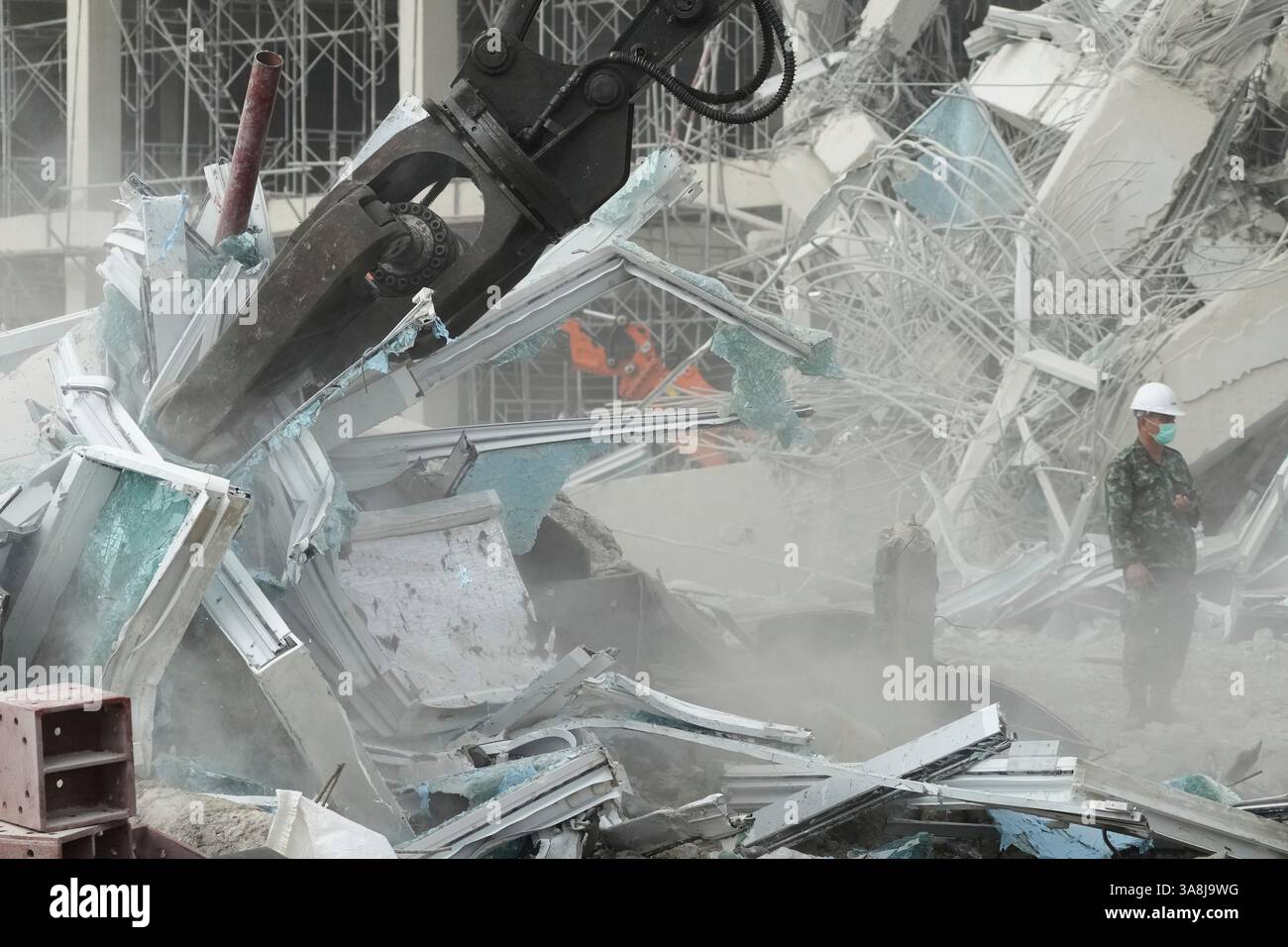 A heavy machine clears the rubble in Bangkok, Thailand, Saturday, March ...