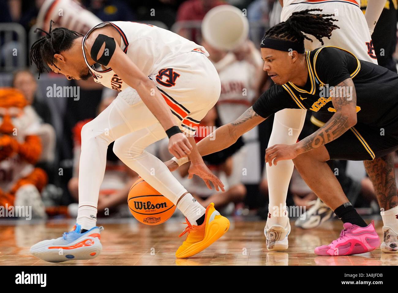 Auburn guard Chad Baker-Mazara (10) and Michigan guard Rubin Jones (15 ...