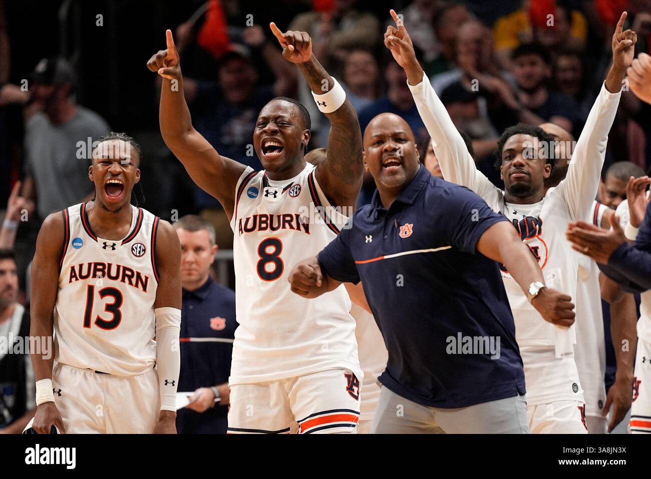 The Auburn bench celebrates during the second half in the Sweet 16 of ...