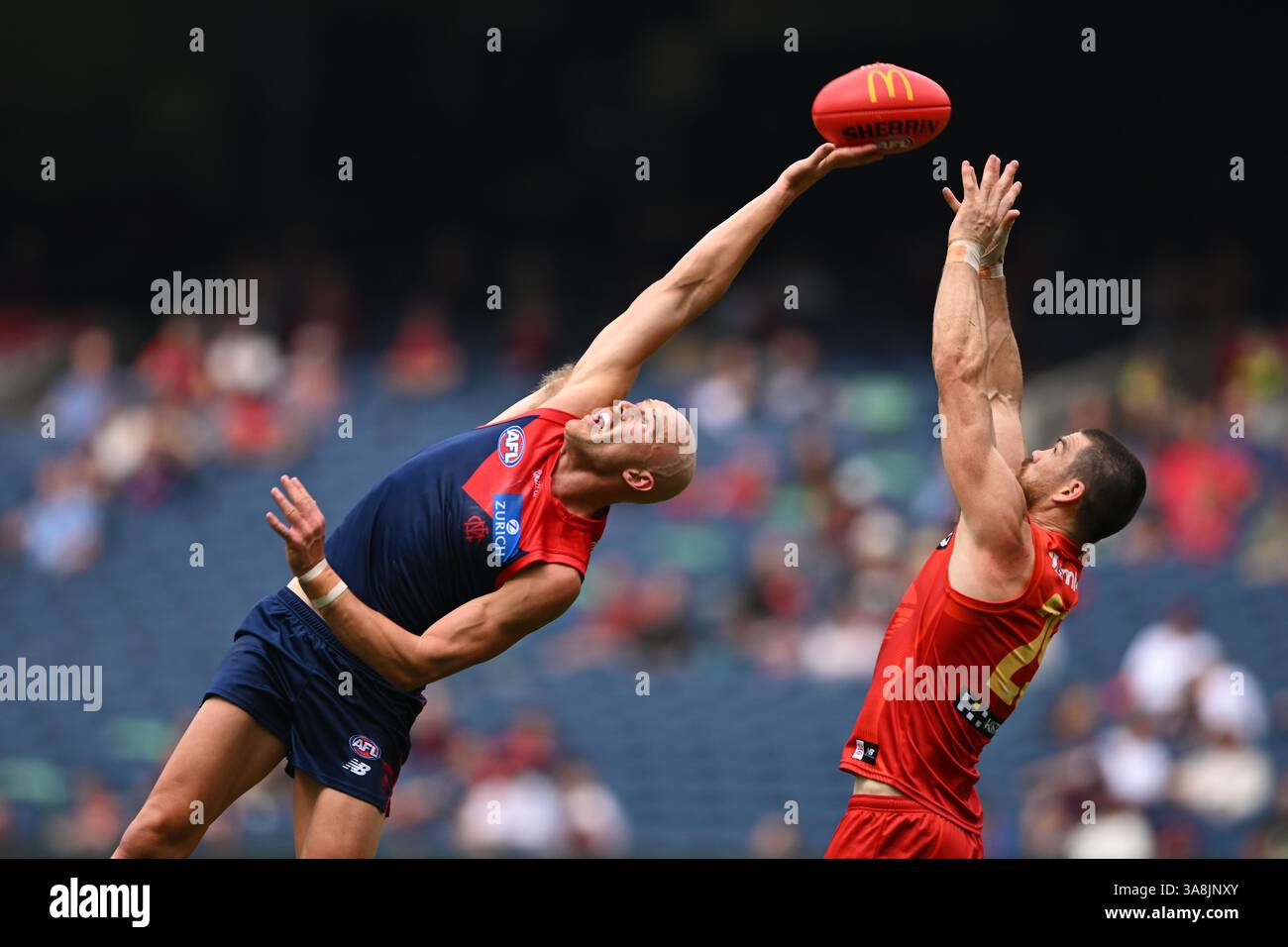 Aidan Johnson of the Demons (left) in action during the AFL Round 3 ...