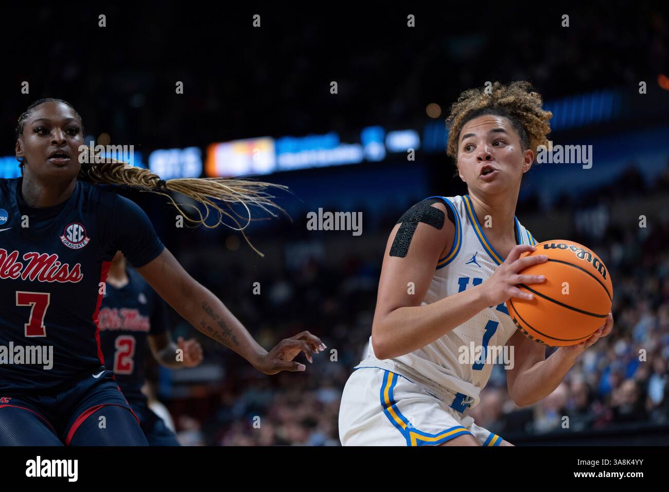 UCLA guard Kiki Rice (1) looks to get around Mississippi forward Starr ...