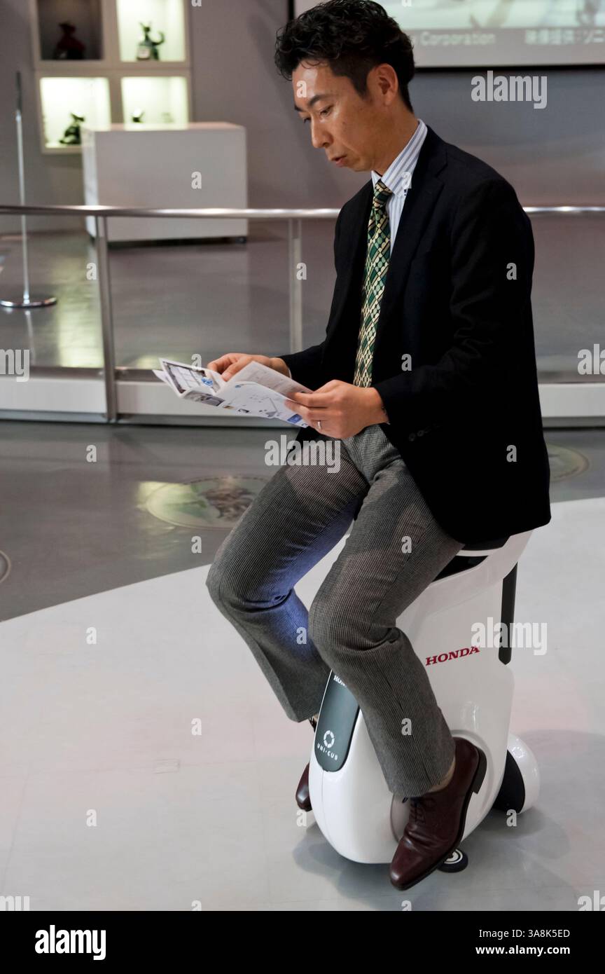 Early model showing rider on Honda's Uni-Cub intuitive transport ...