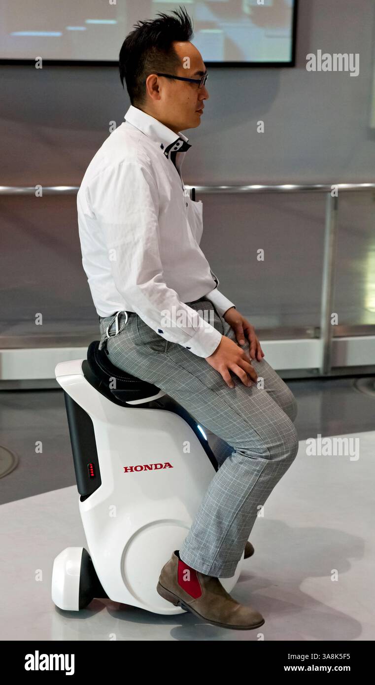 Early model showing rider on Honda's Uni-Cub intuitive transport ...