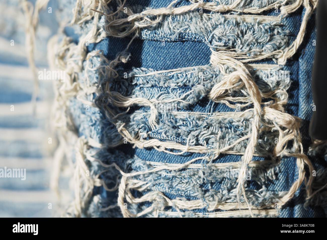 Denim texture showcases frayed details in natural light Stock Photo - Alamy