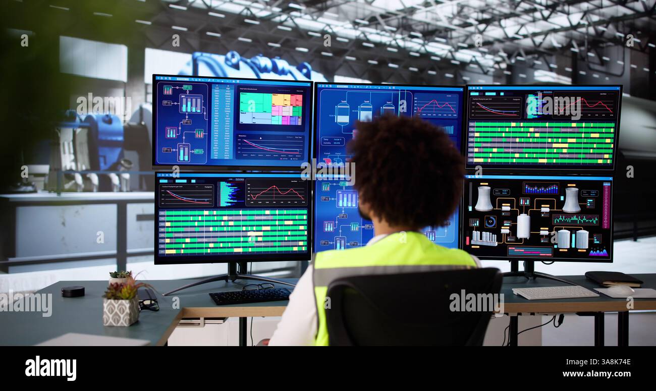 Black engineer checking power plant screens using Scada system Stock ...