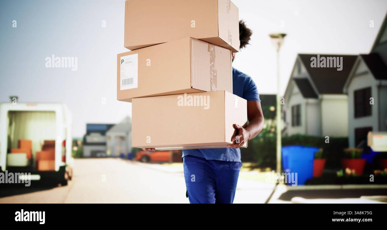 African American delivery man dropping packages while walking through ...