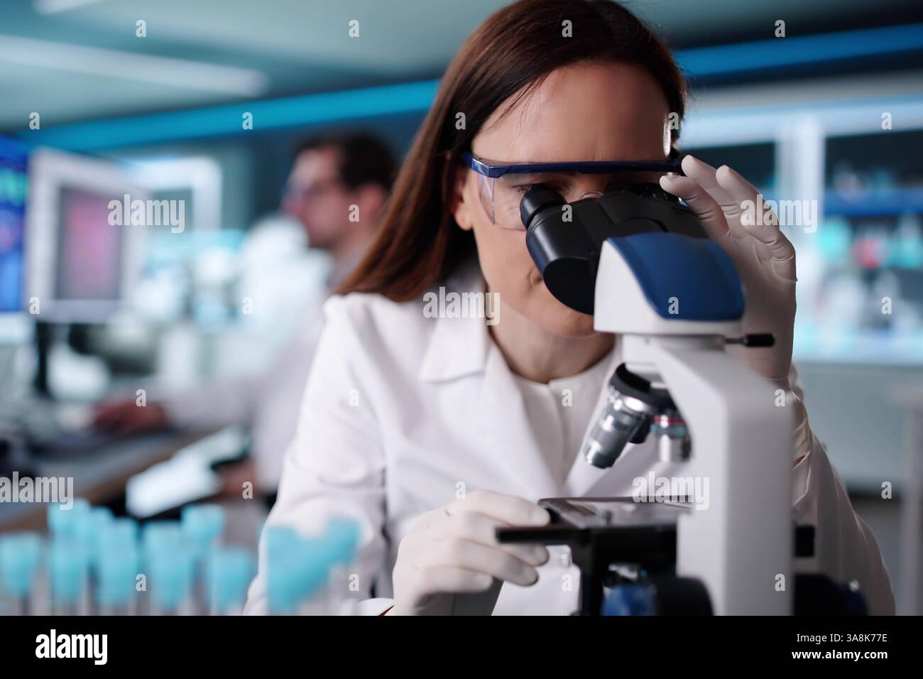 Science lab researchers analyzing vaccine development using advanced technology and equipment ...