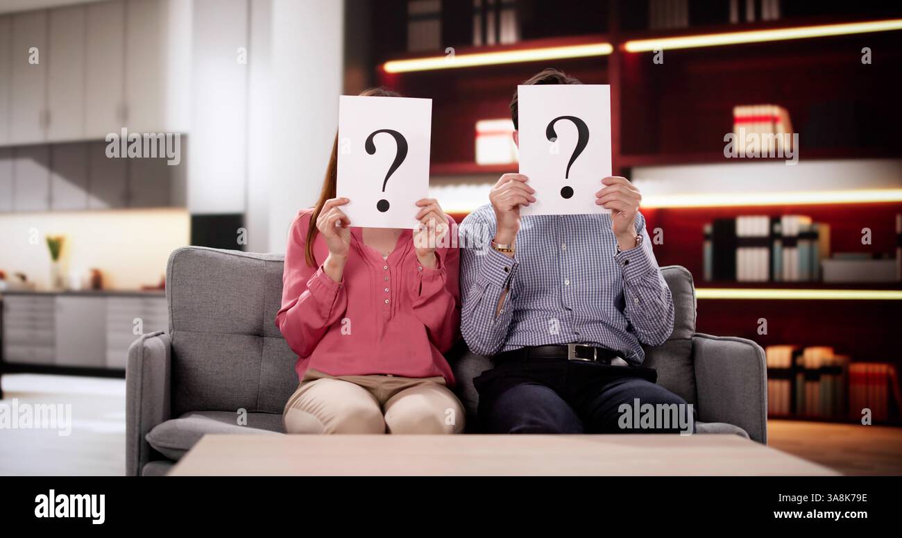 Confused Couple Holds Question Mark in front of unknown faces Stock ...