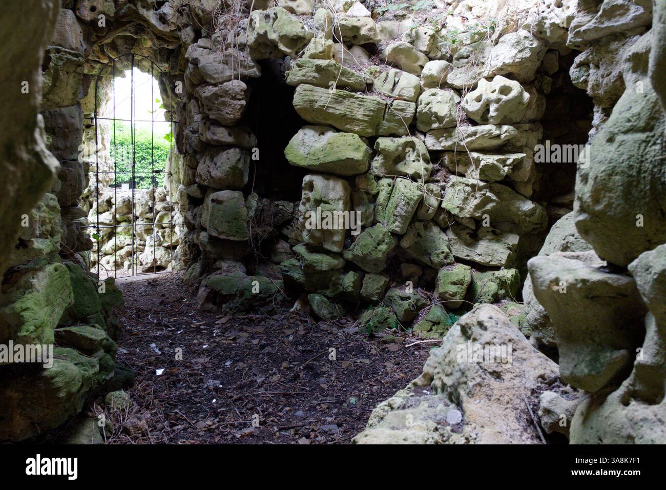 Man made rock cave in a garden Stock Photo - Alamy