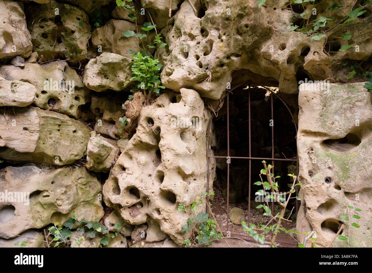 Man made rock cave in a garden Stock Photo - Alamy