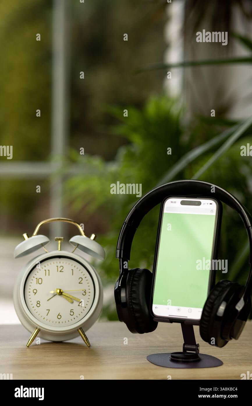 A smartphone with a green screen. Chroma key. Retro alarm clock. Social ...