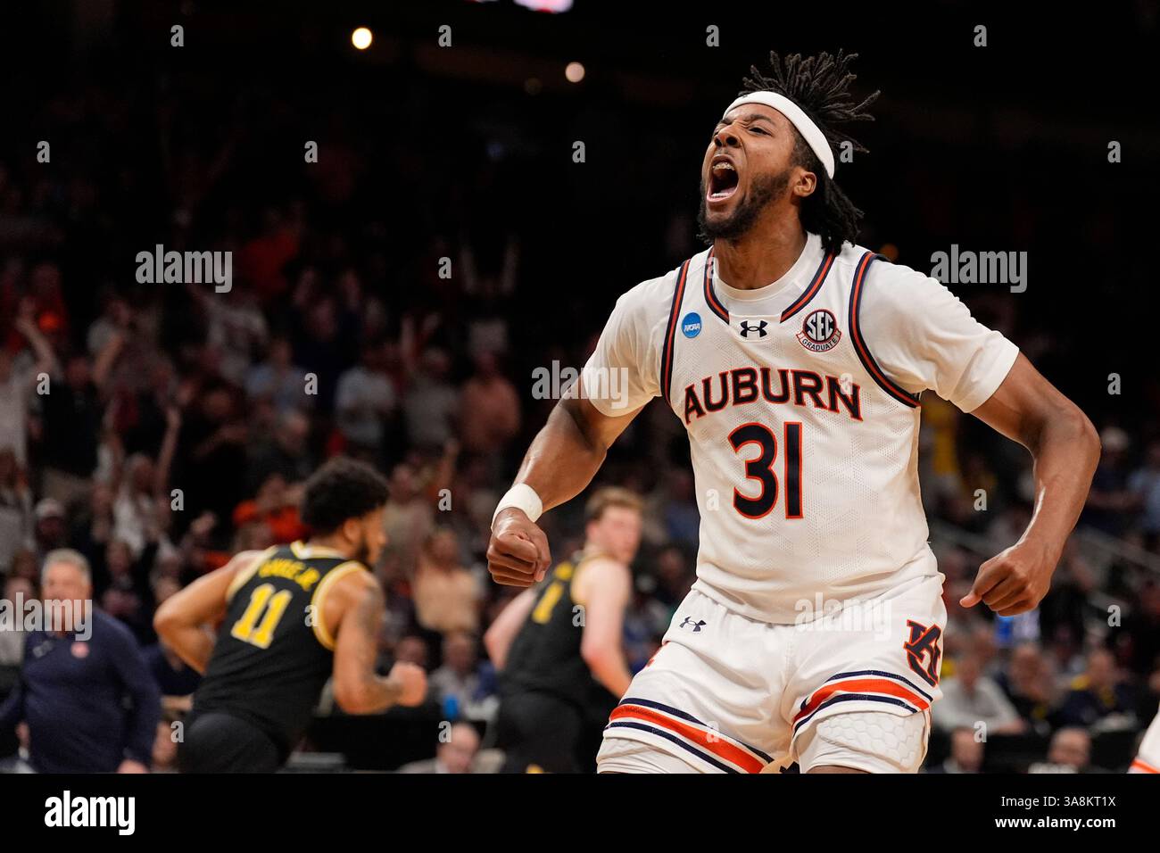 Auburn forward Chaney Johnson (31) celebrates scoring in the second ...