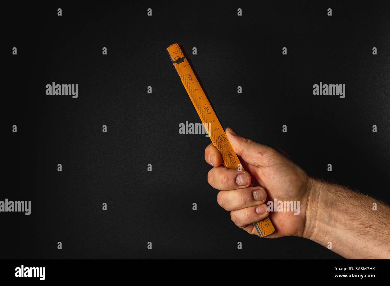 A person holds a measuring tool in their hand, showcasing its detailed ...