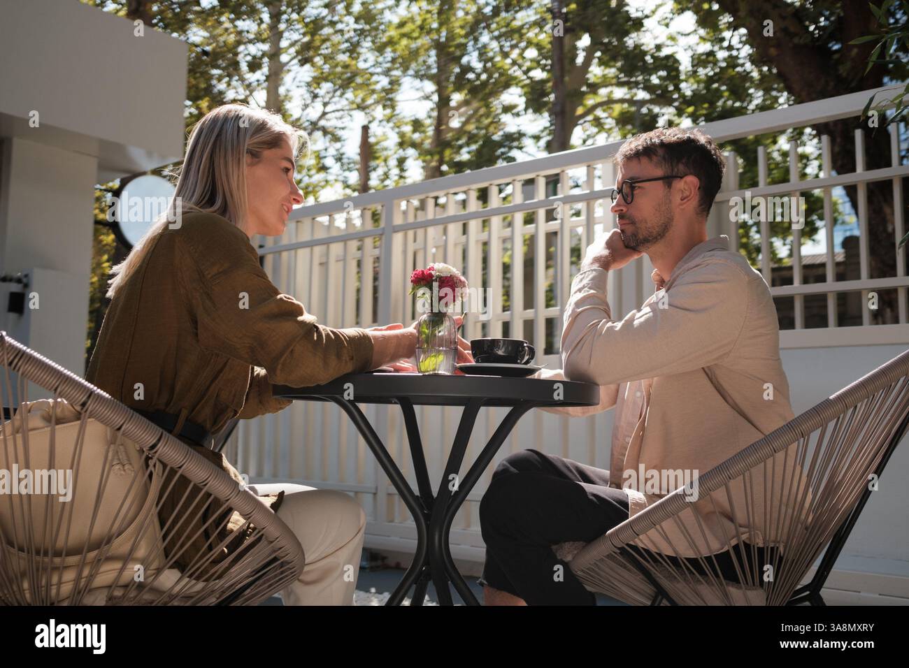 Outdoor cafe meeting between two friends enjoying coffee together Stock ...