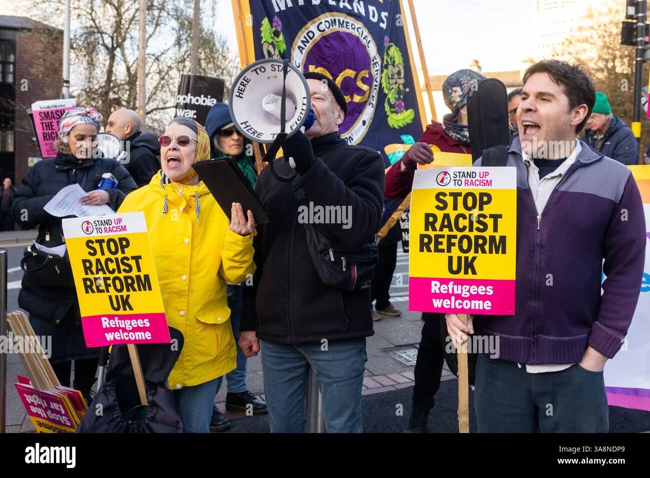 Birmingham, UK. 28 MAR, 2025. Protestors chant outside at the Reform UK ...