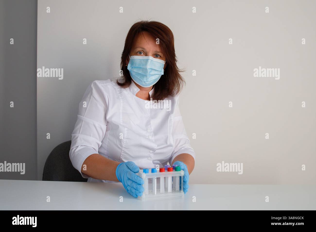 Medical laboratory nurse preparing test tubes for making blood tests ...