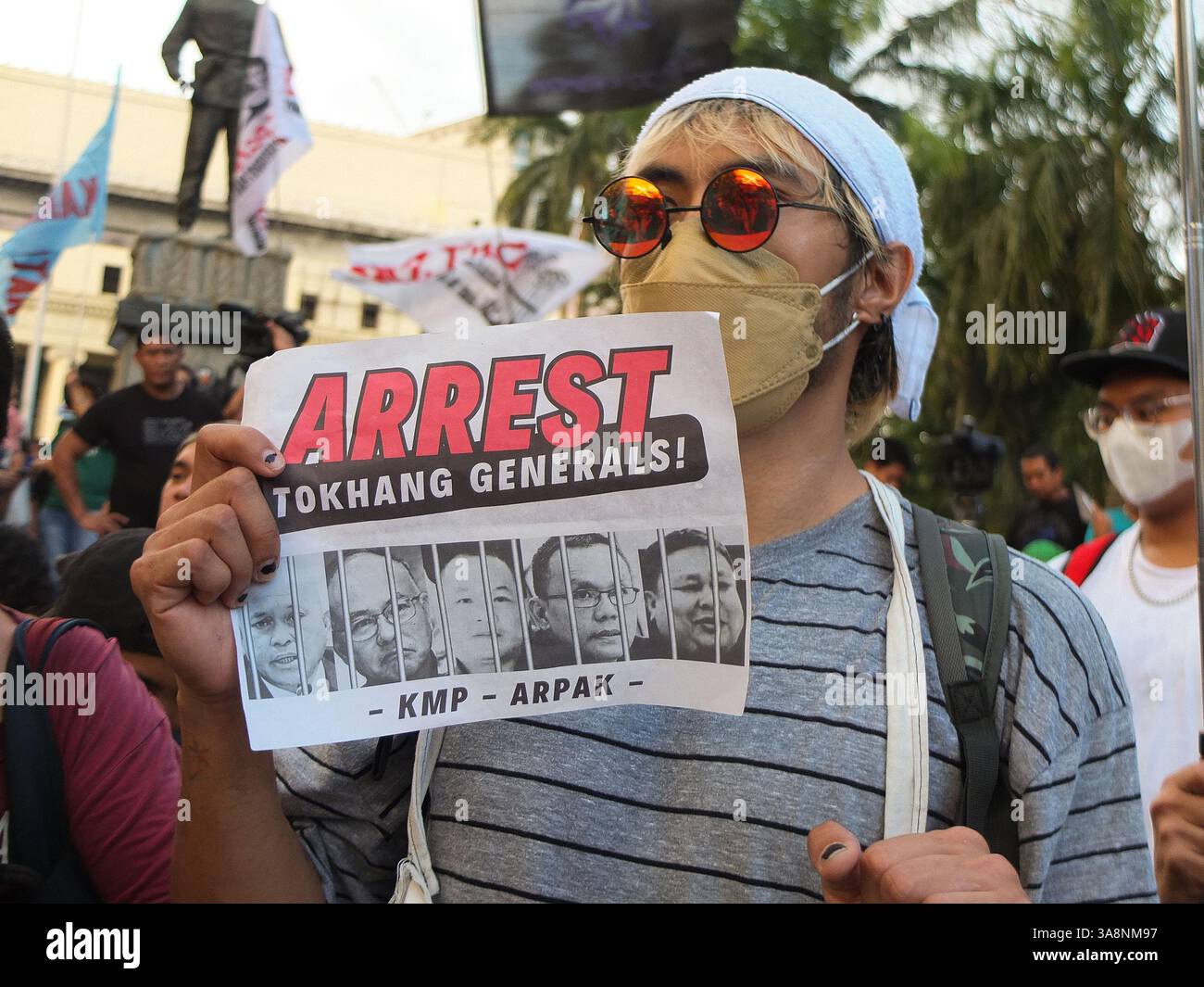 A protesters holds a placard with a slogan, to arrest all the police ...
