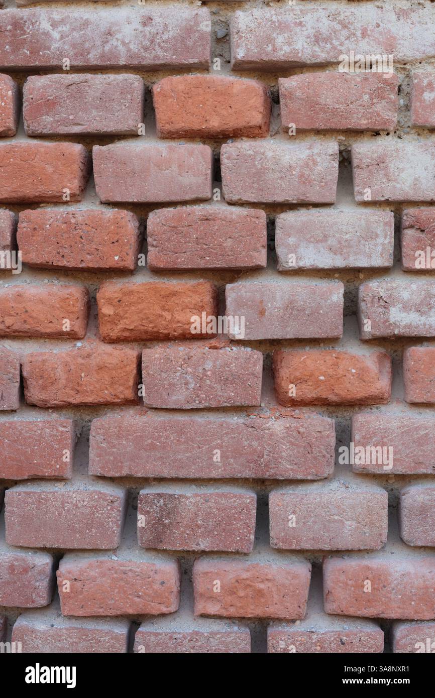 unmaintained old brick wall made of orange old bricks with completely ...