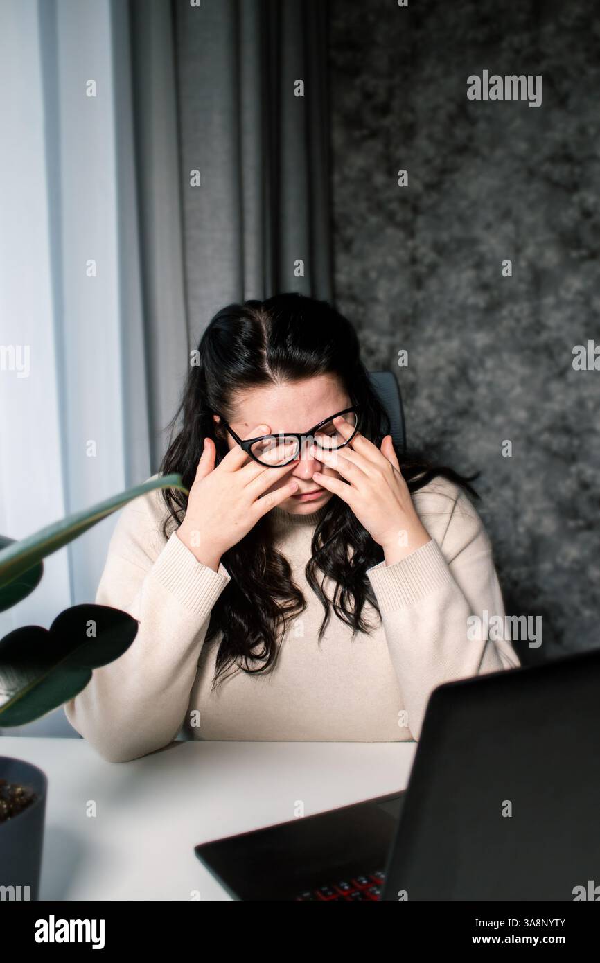 Tired business woman having fatigue and headache during work with ...