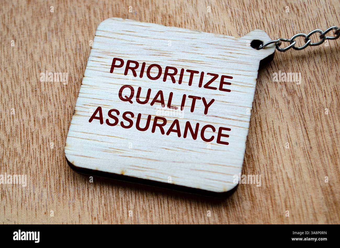Top view of Prioritize Quality Assurance text on wooden block. Quality ...