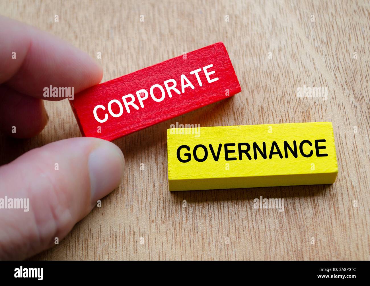Hand holding Corporate Governance text on colored wooden blocks ...