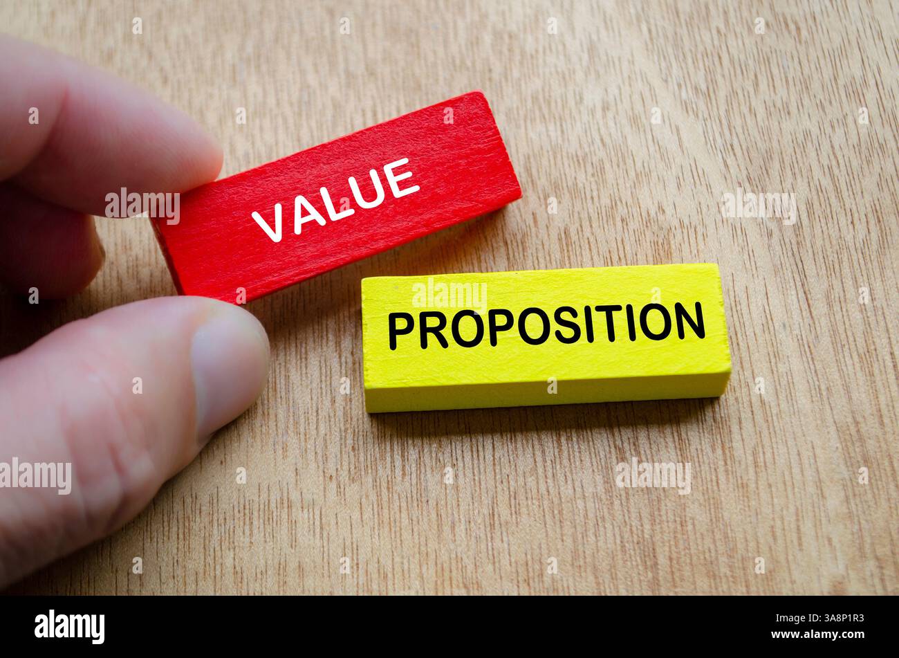 Hand holding Value Proposition text on colored wooden blocks Stock ...
