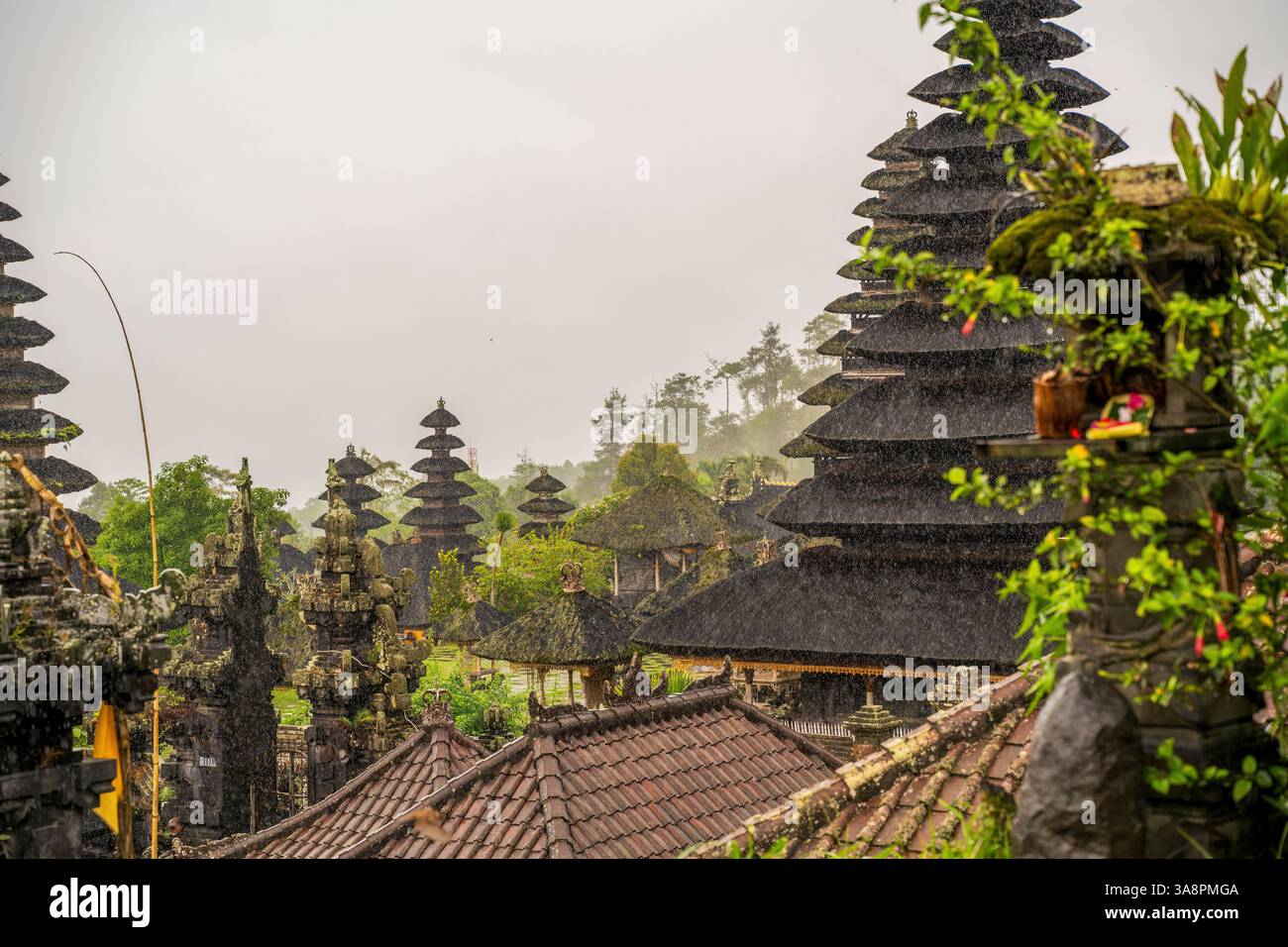Misty rain falls over ancient Balinese temple complex with distinctive ...