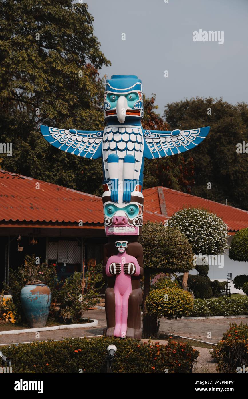 A Colorful Totem Pole Featuring Vibrant Designs Amidst Surrounded ...