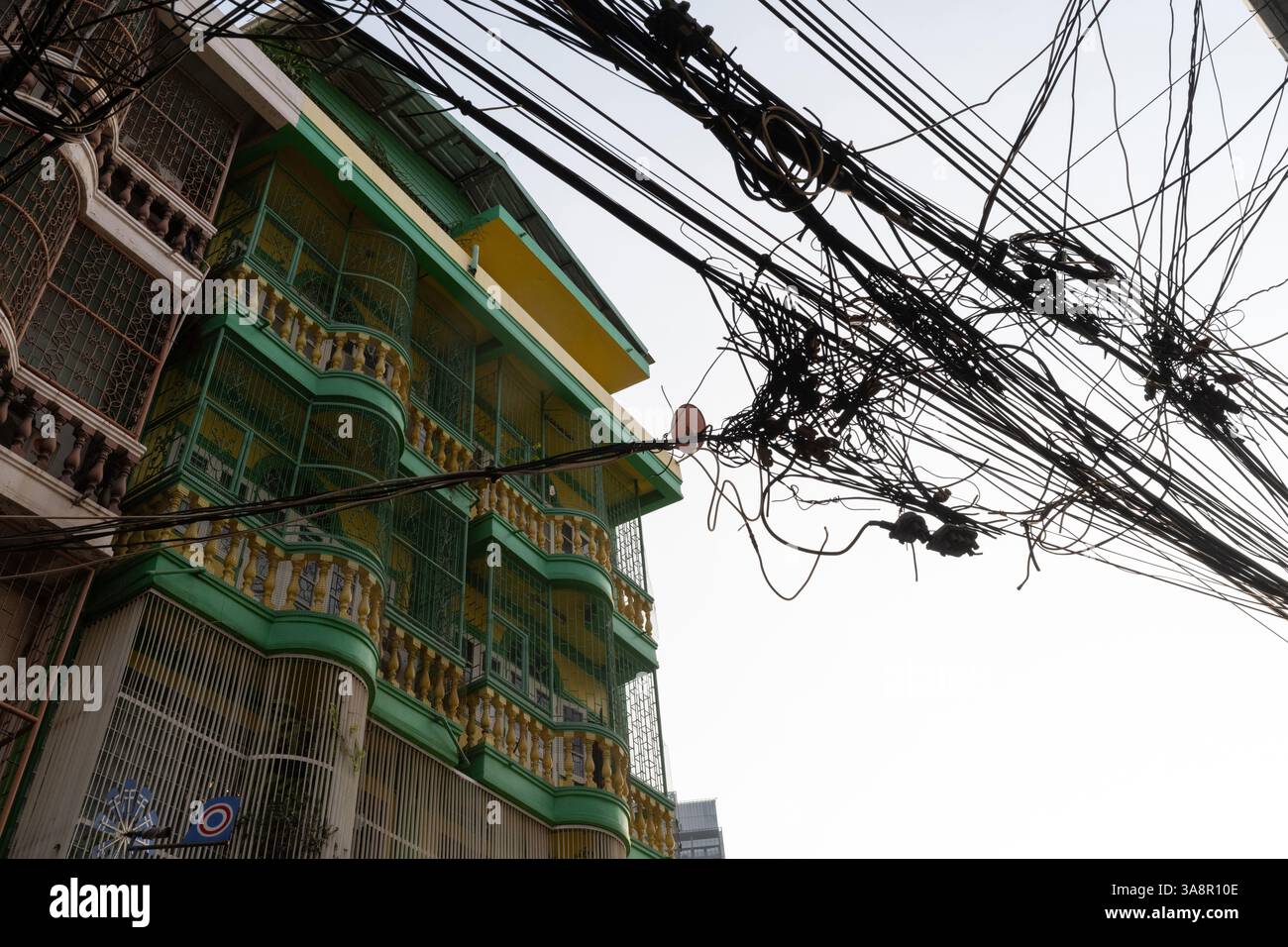 A tangled mess of cables and wires used for phone and internet ...