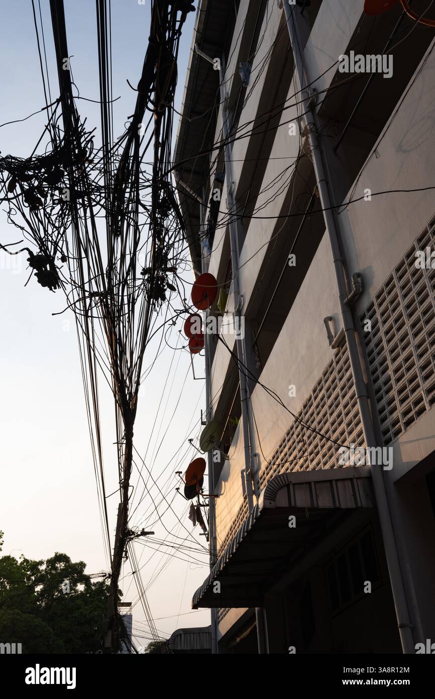 A tangled mess of cables and wires used for phone and internet ...