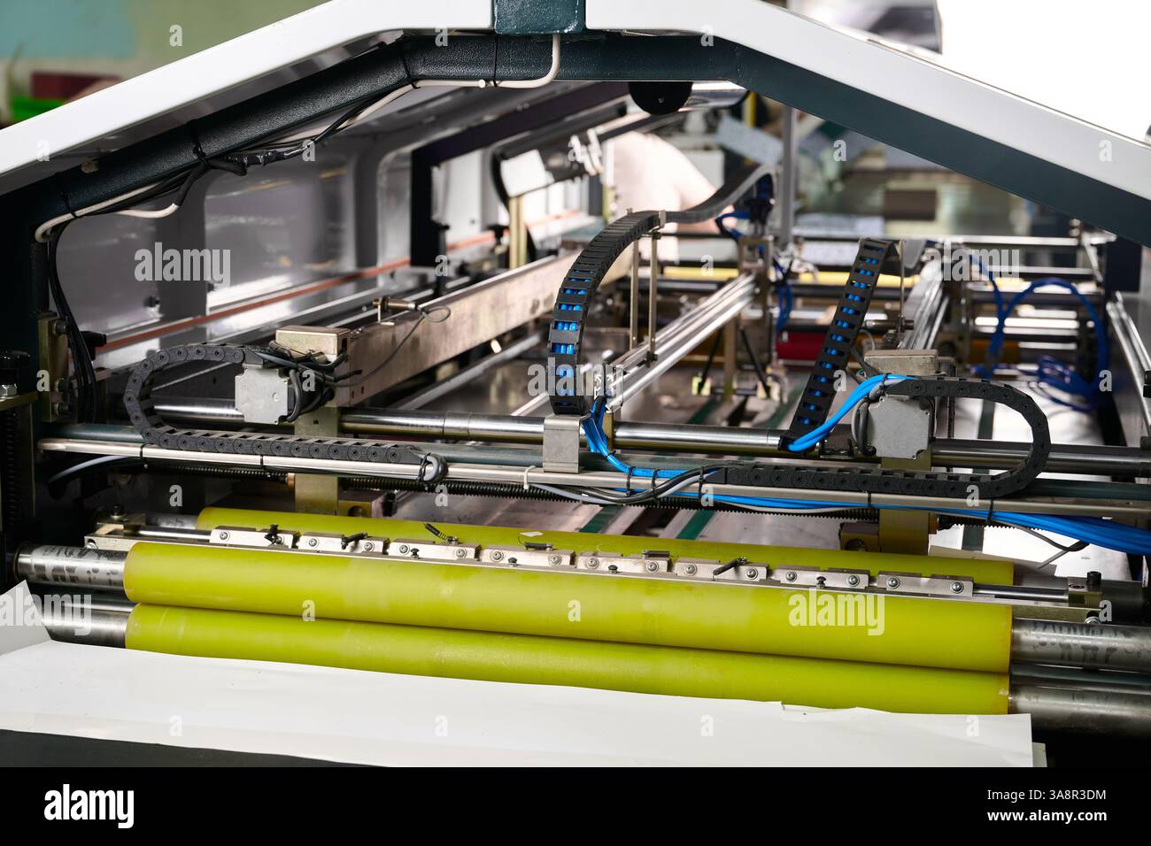 Innovative machine expertly folding cardboard box flaps in a busy ...