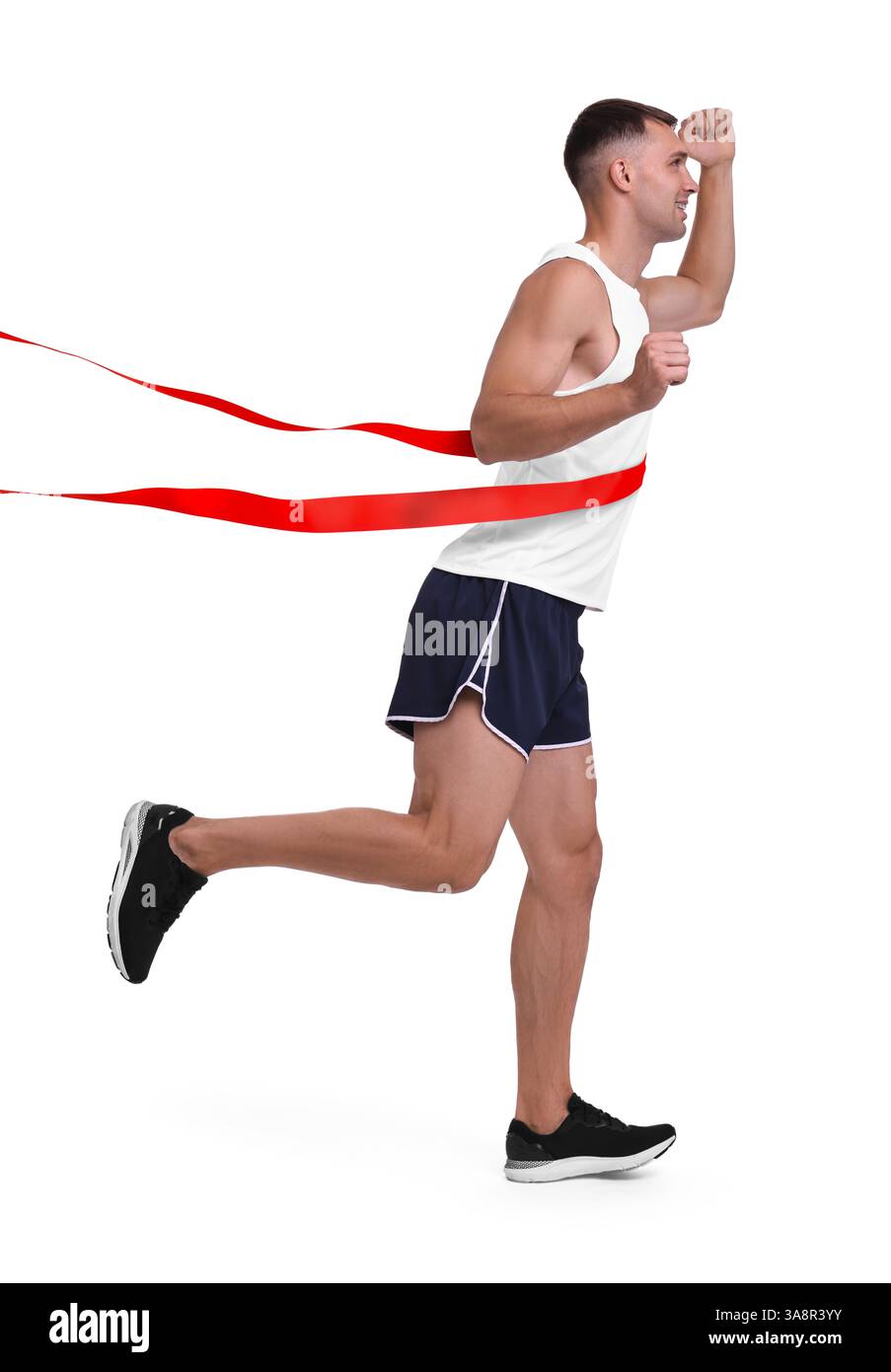 Happy sportsman crossing red finish line ribbon on white background ...