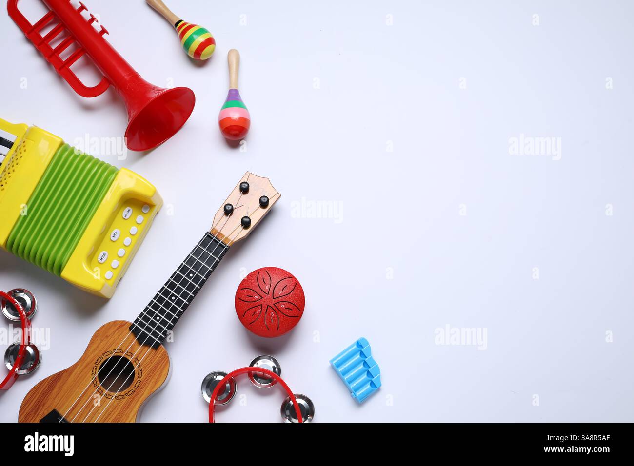 Flat lay composition with different toy musical instruments on white ...
