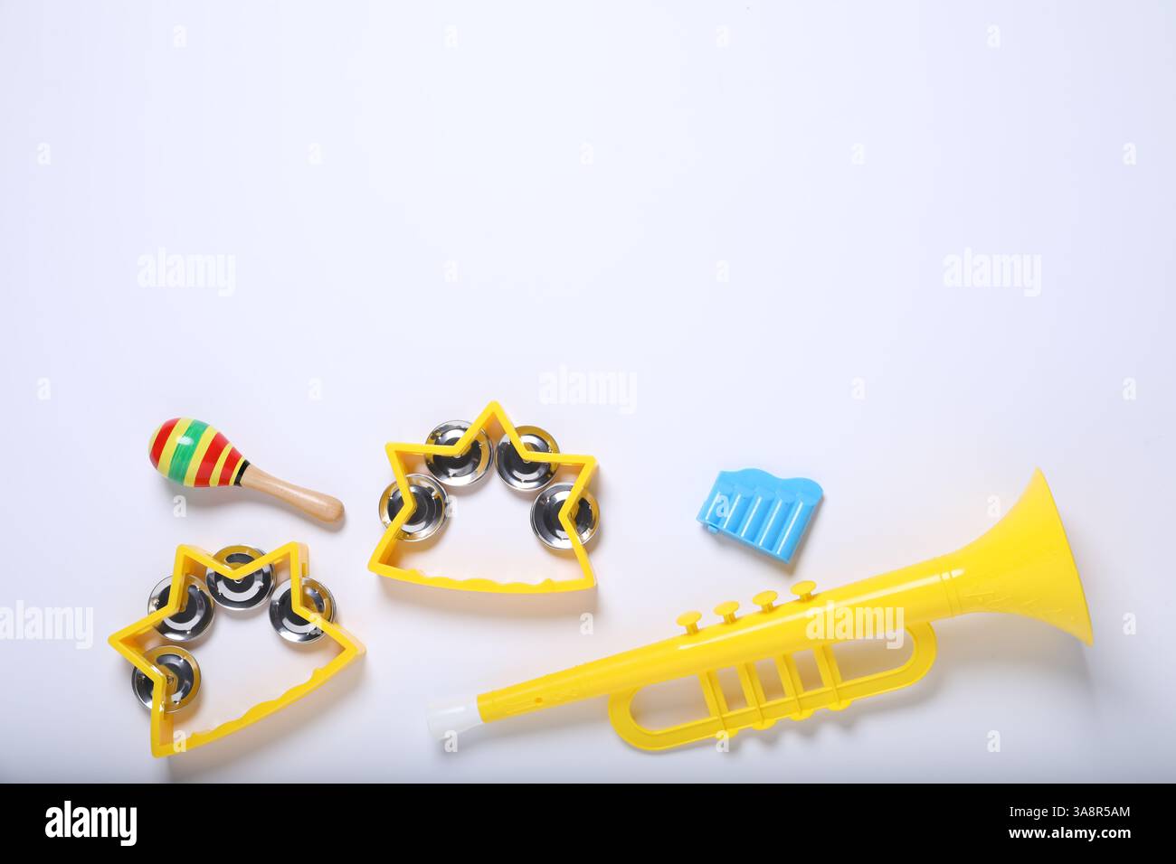 Flat lay composition with different toy musical instruments on white ...