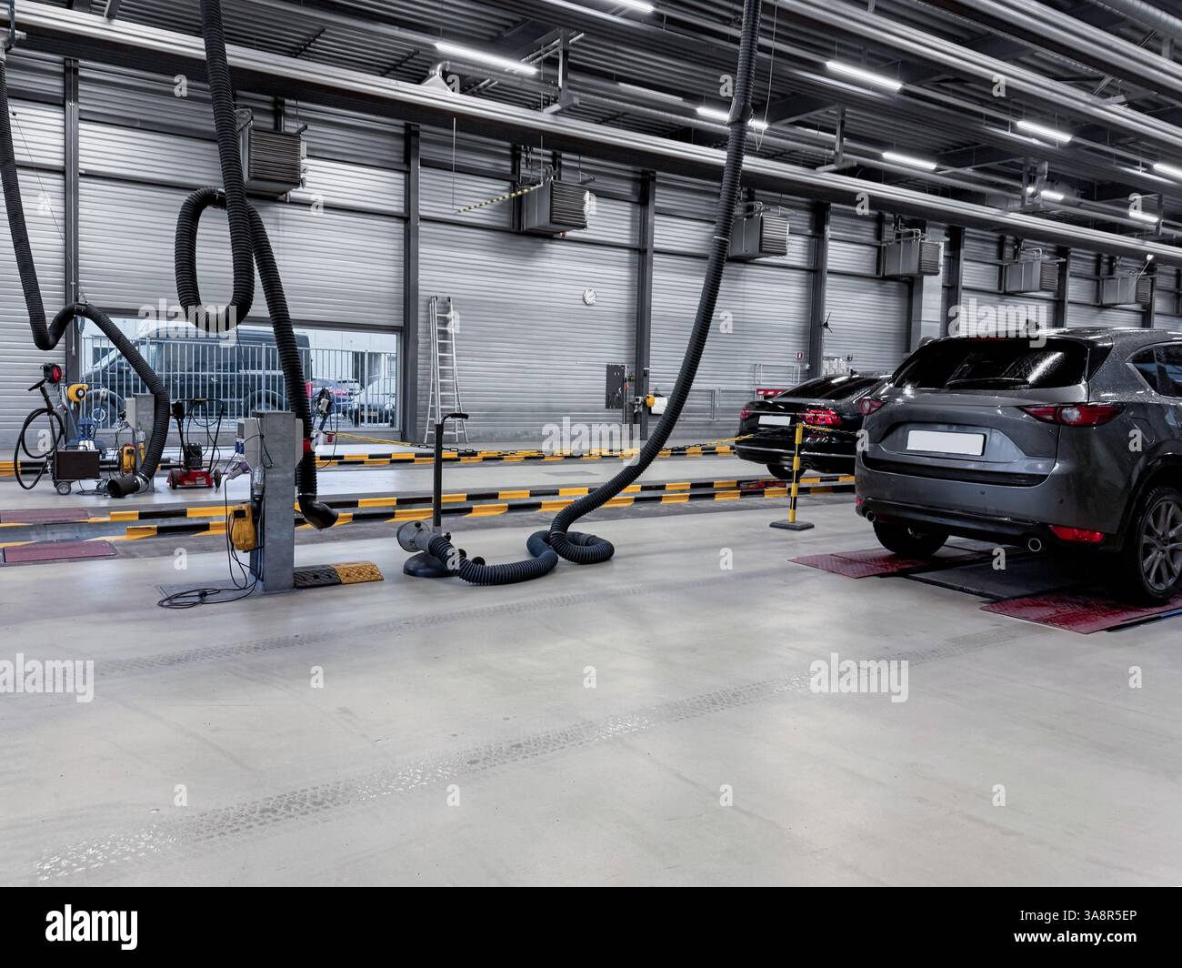 Modern cars undergoing procedure of vehicle inspection at station Stock ...