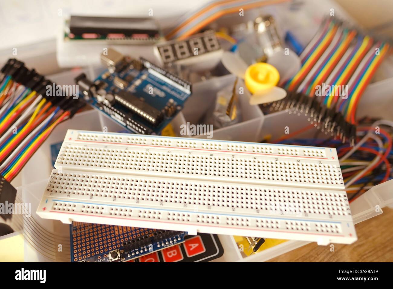 Electronics components, Breadboard in box with jumper wires and breadboard, symbolizing DIY ...