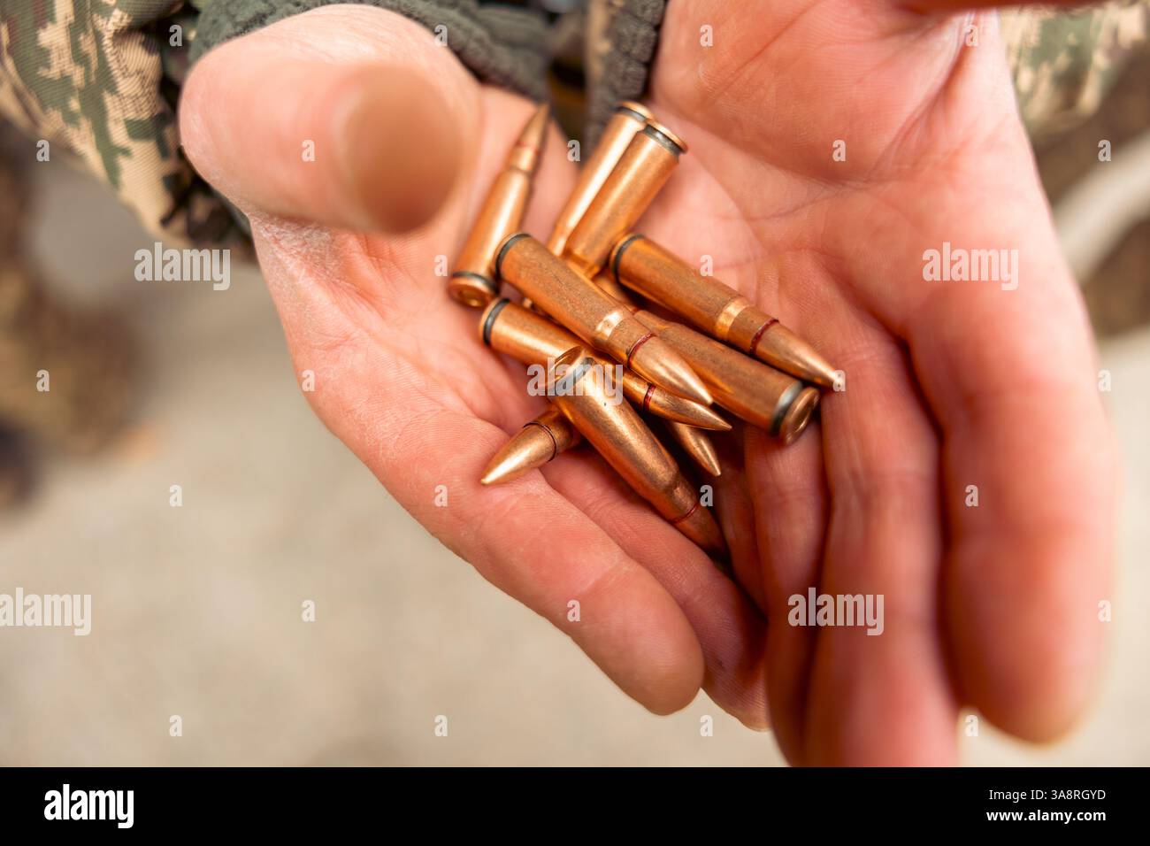 A soldiers hand with cartridges is a symbol of determination, strength ...