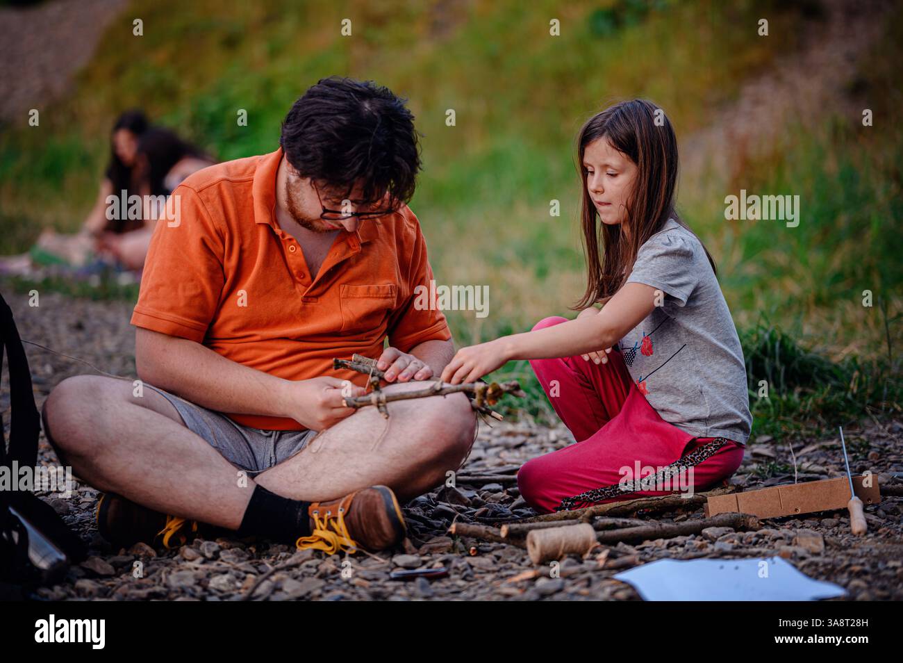 A father and his daughter work together on a woodcraft project in ...