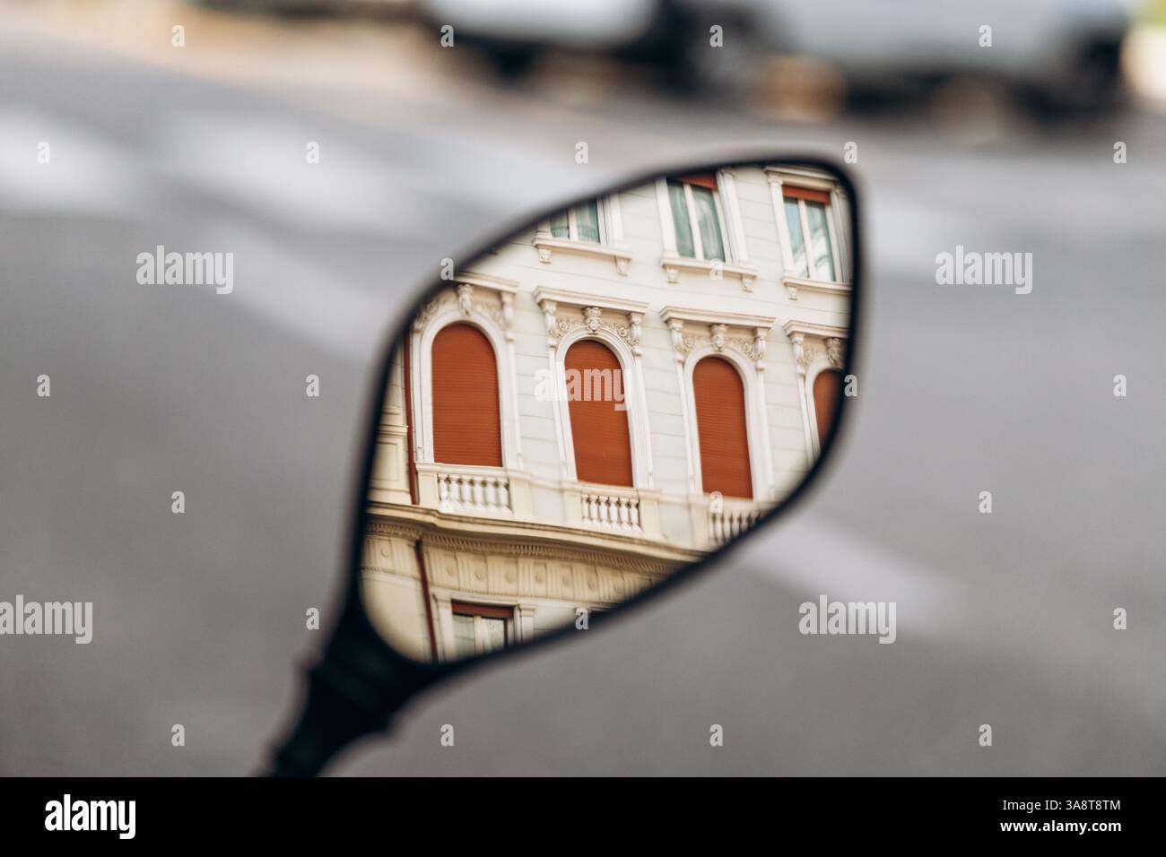 A reflection of an elegant building in the side mirror of a vehicle ...
