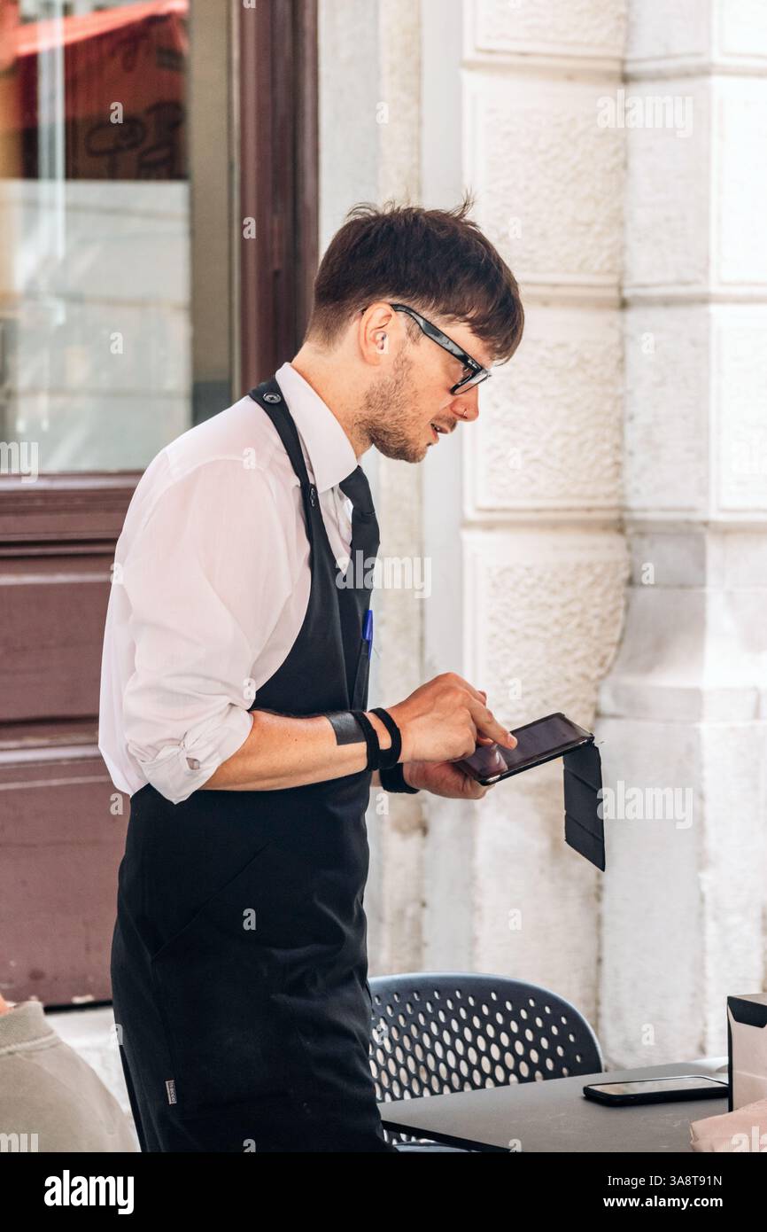 Trieste, Italy - August 18, 2024: Waiter at the legendary Caffe San ...