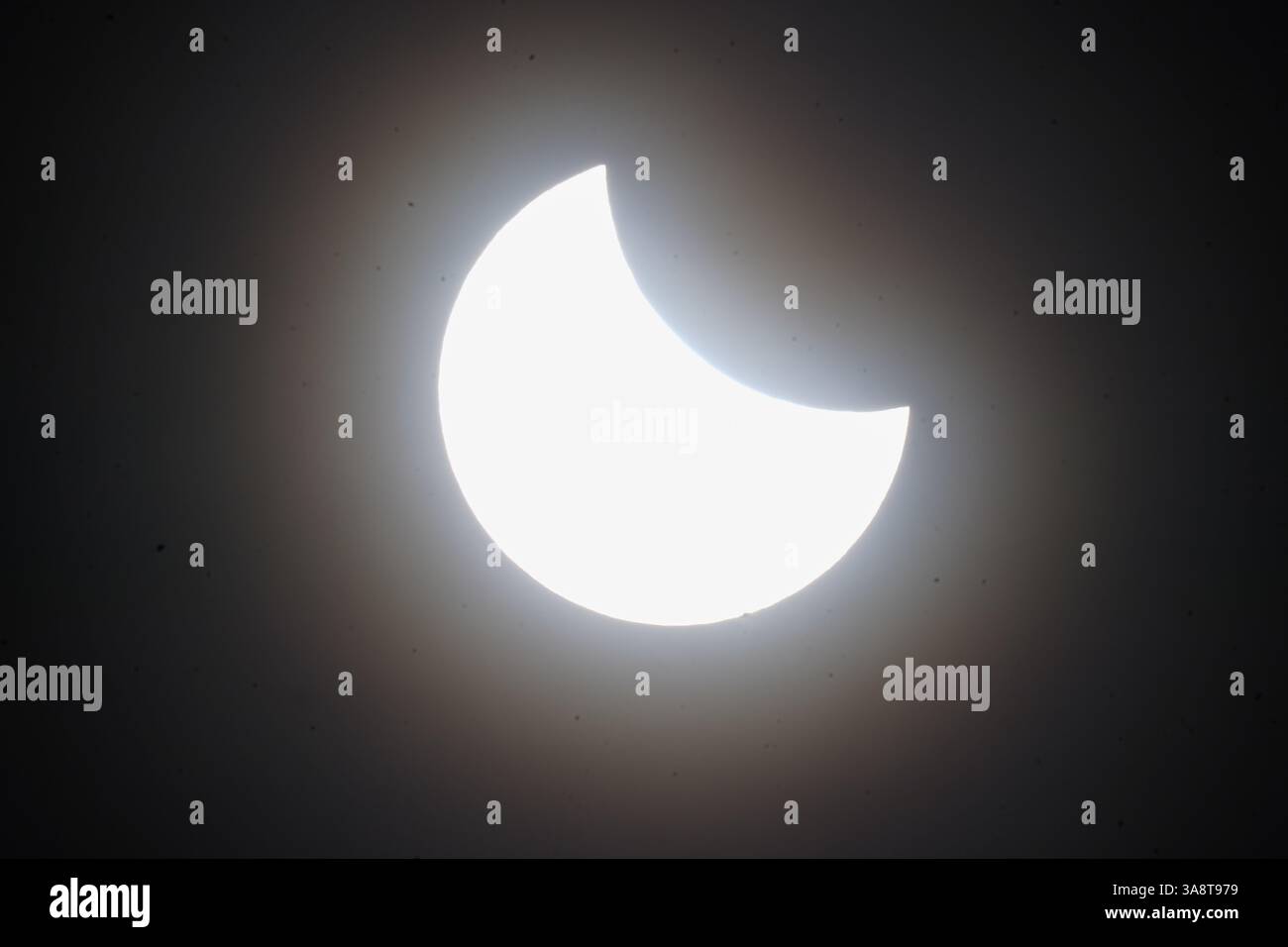 A partial solar eclipse seen from Warwickshire. The phenomenon occurs ...