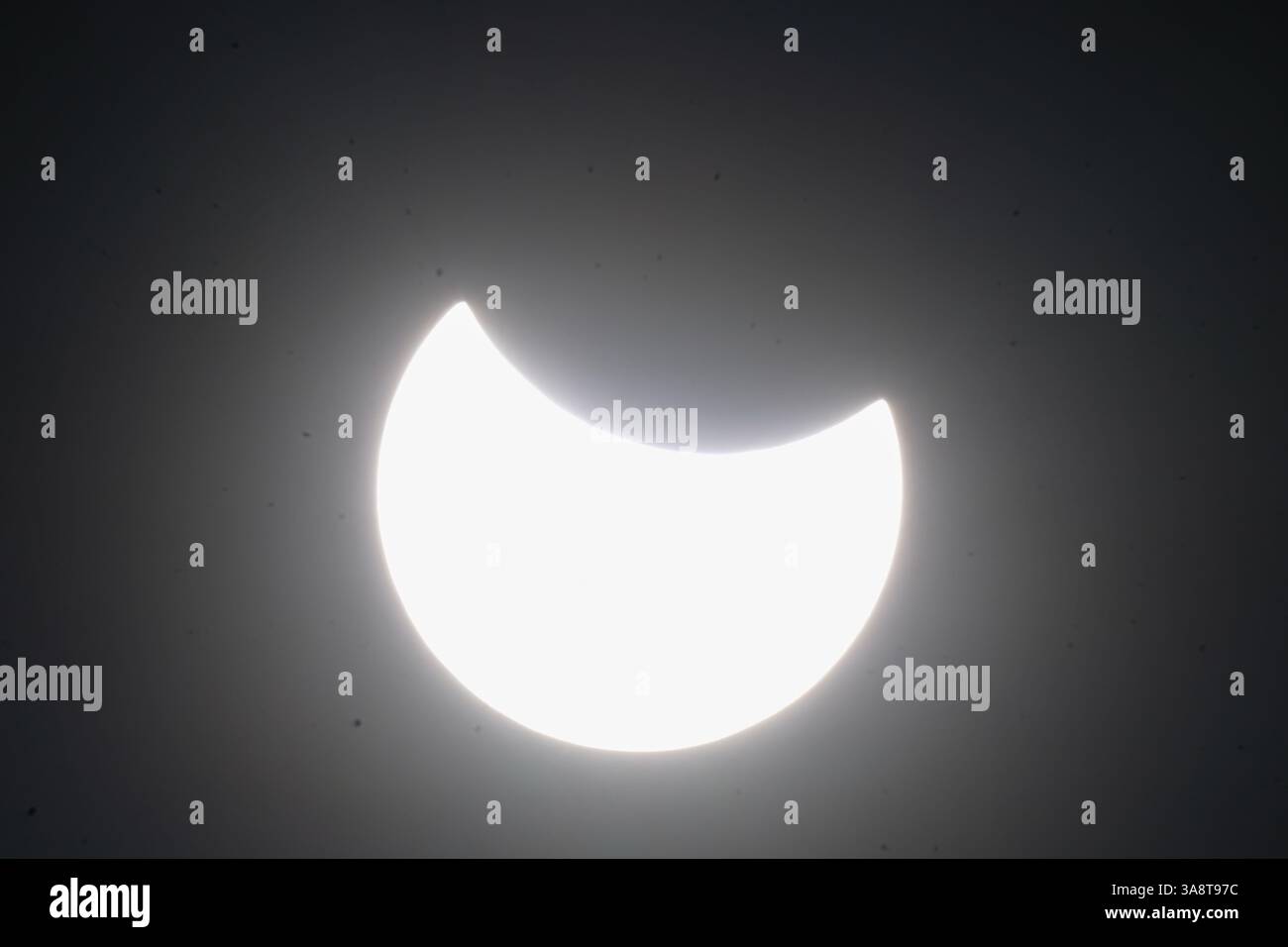 A partial solar eclipse seen from Warwickshire. The phenomenon occurs ...