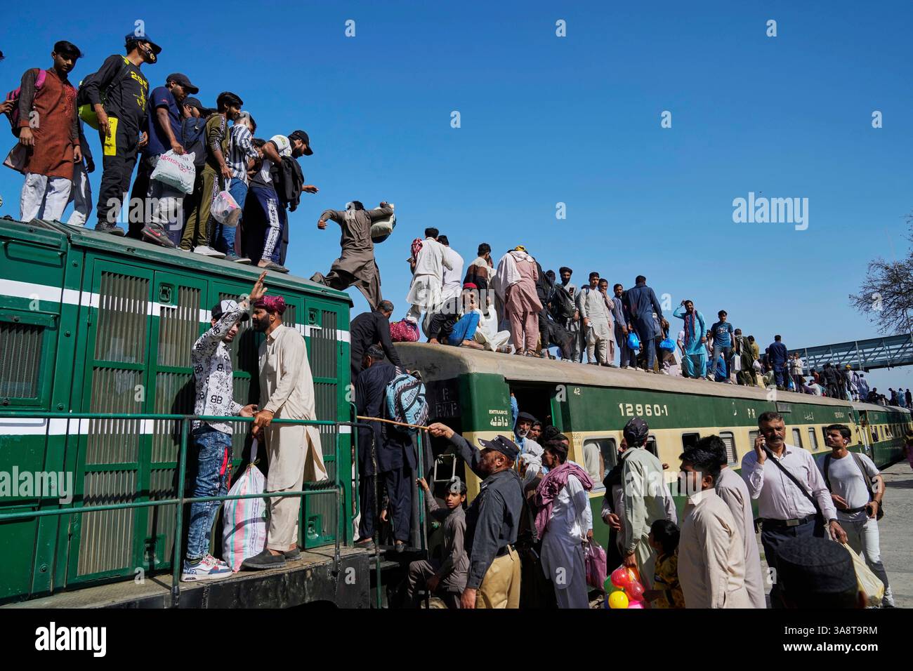People board an overcrowded passenger train to reach their homes to ...