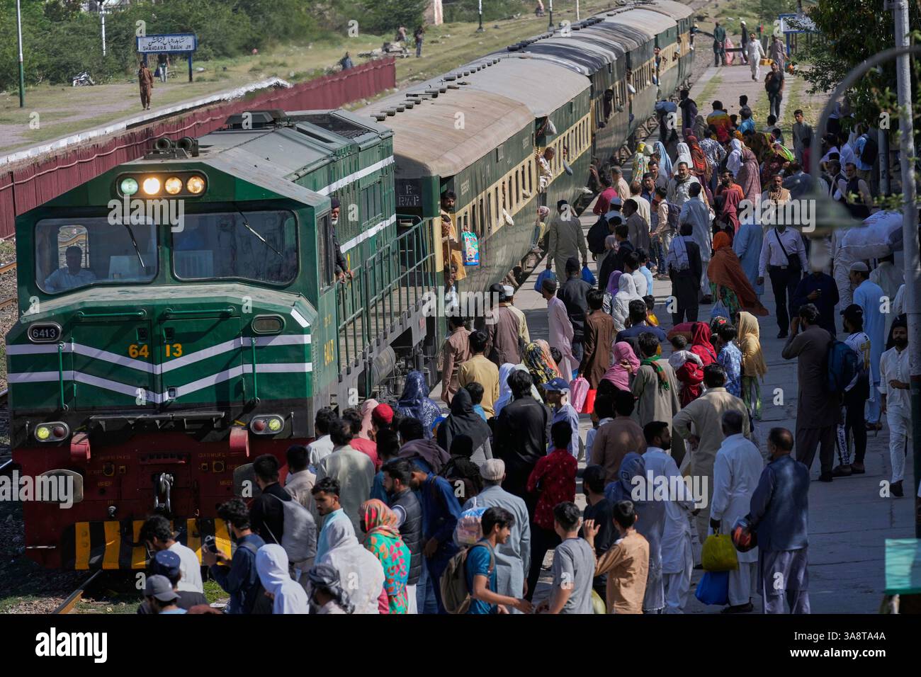People board an overcrowded passenger train to reach their homes to ...