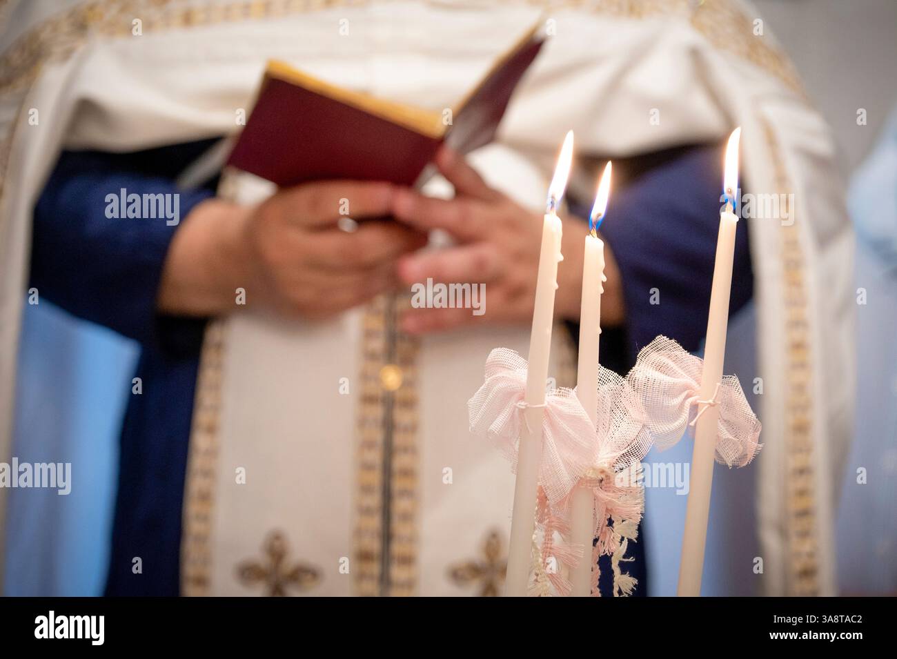 The priest reading the holy gospel in front of the font, during a greek ...