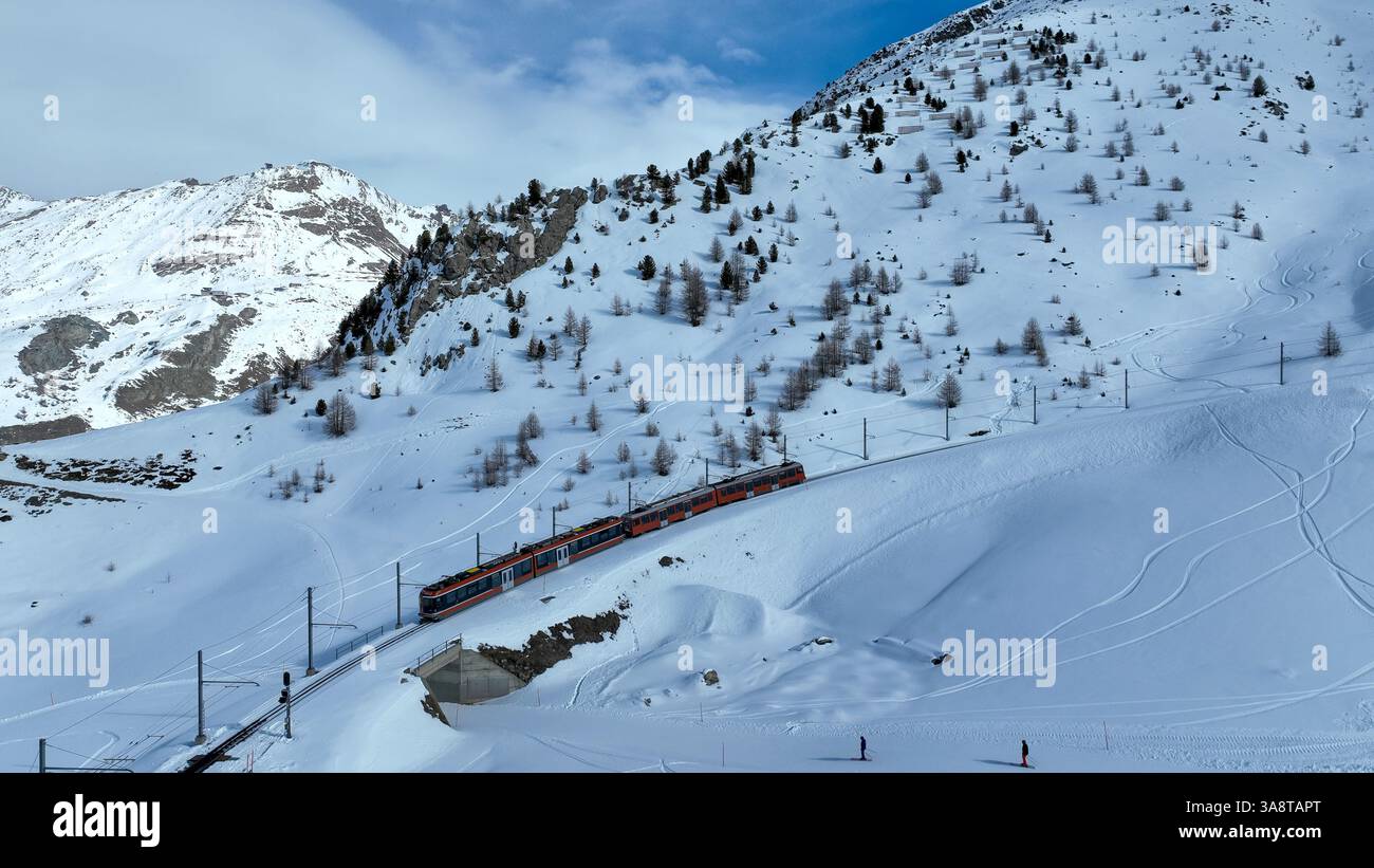 Cogwheel train of the Gornergrat Railway climbing the mountain facing ...