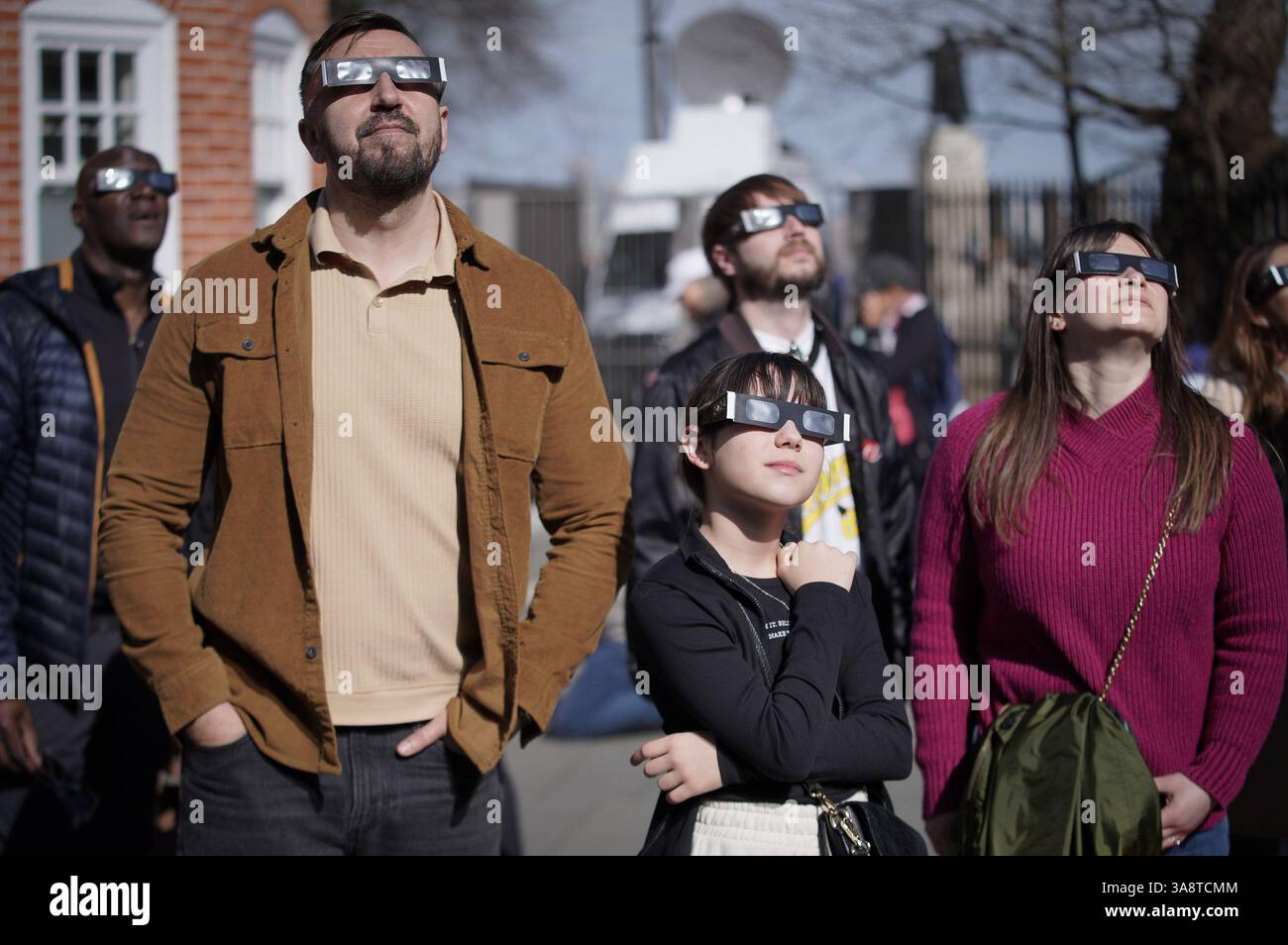 London, UK. 29th March, 2025. UK Weather: Watching the partial solar ...