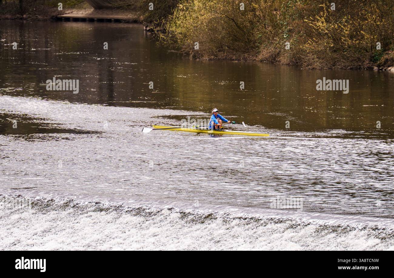 29 March 2025, Hesse, Weilburg: A sportswoman is out on the Lahn with ...
