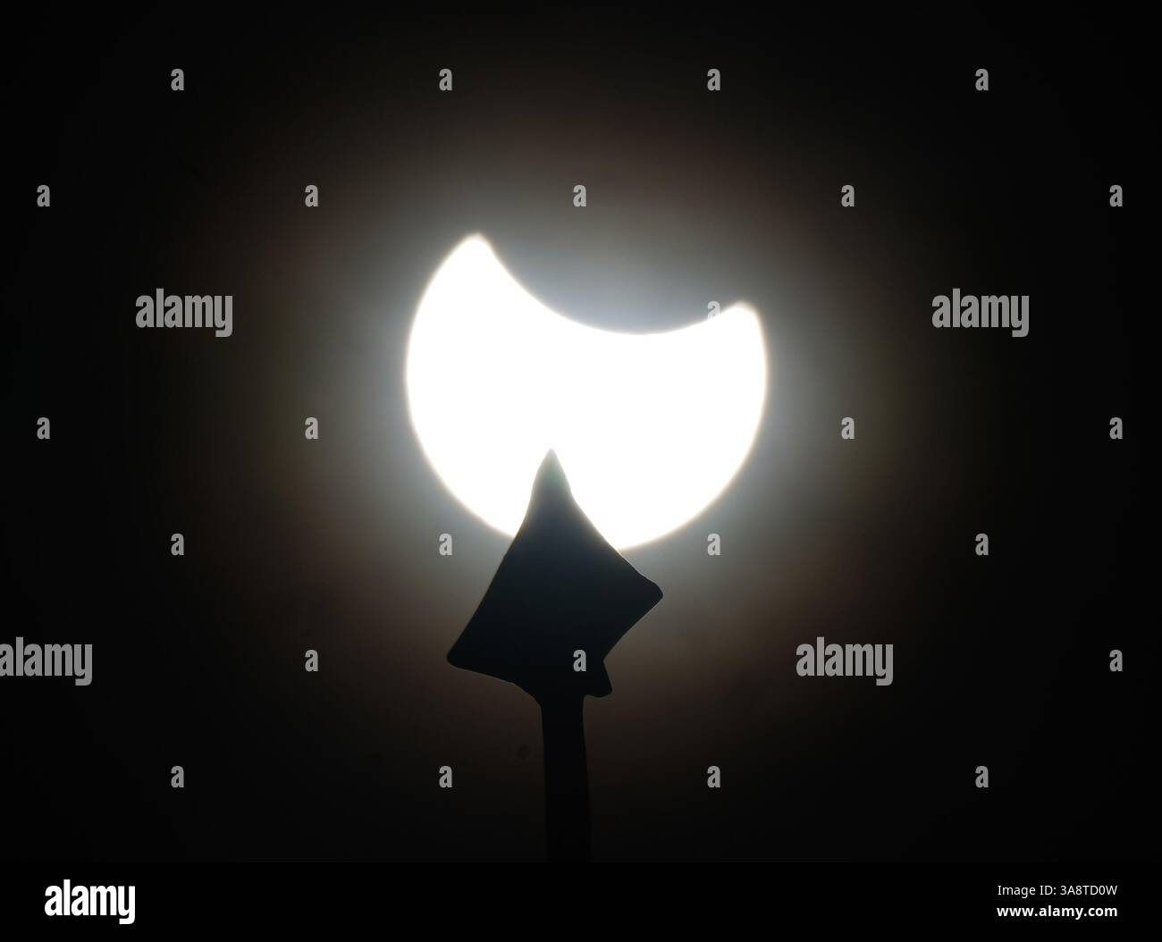 A partial solar eclipse is seen above the roof of the Greenwich foot ...